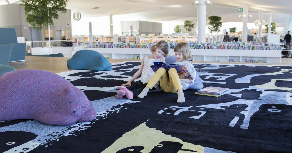The renovated children’s section at Oodi invites visitors to read books ...
